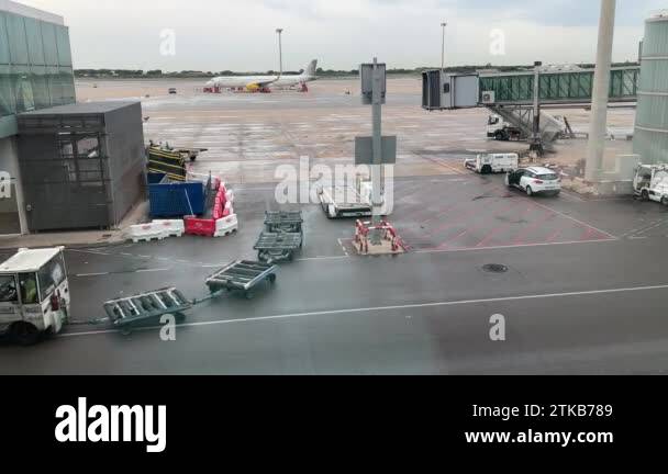 empty baggage transporter and boarding gate at airport field. High ...