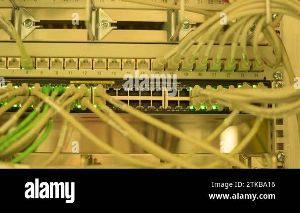 blinking LED lights in a server rack with RJ45 and fiber optic cable ...