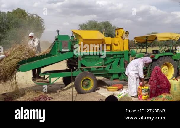 21 December 2022 Reengus, Rajasthan, India. Tractor working with ...
