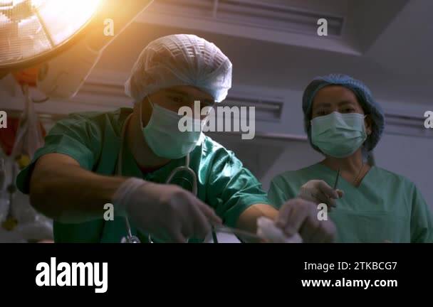 A surgeon diagnosing and identifying an elderly woman's heart problem ...