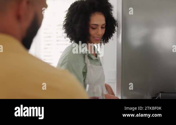 Wine, toast and couple in the kitchen to cook a meal for date, dinner ...