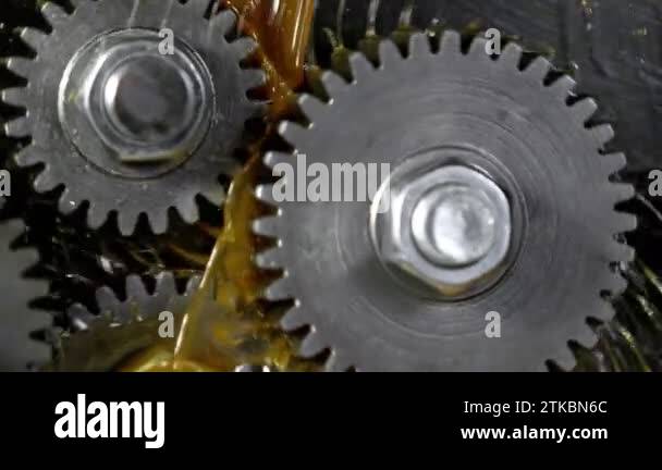 Super Slow Motion Detail Shot of Gear Mechanism and Oil on Dark ...