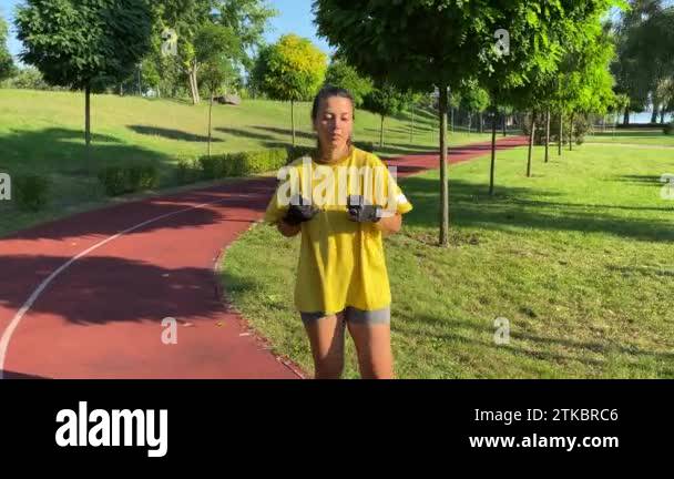 Sporty multiracial young woman in sport gloves engages dynamic boxing ...