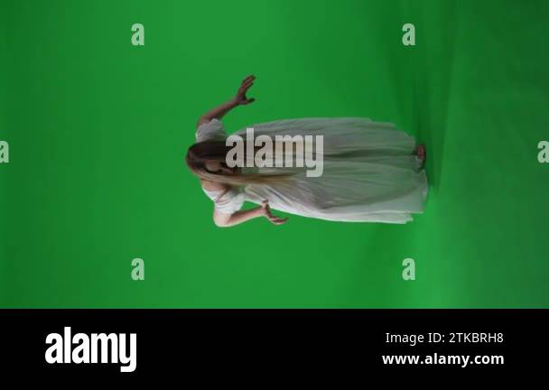 Full-size vertical green screen, chroma key video of a posessed female ...