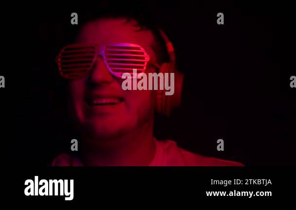 A handsome man at the event listens musically with a smile in the ...