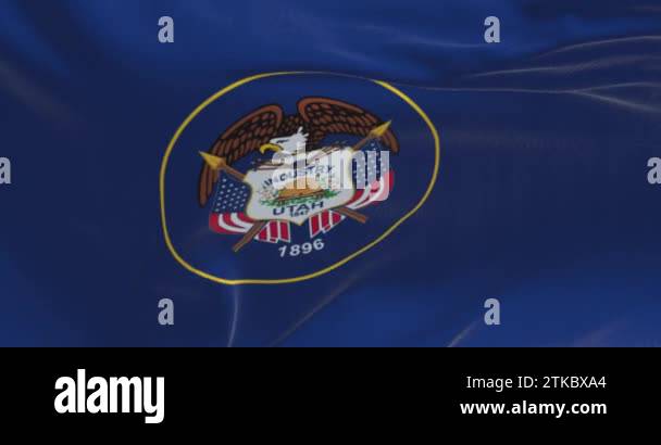 Close-up of Utah state flag waving. State seal encircled in a golden ...
