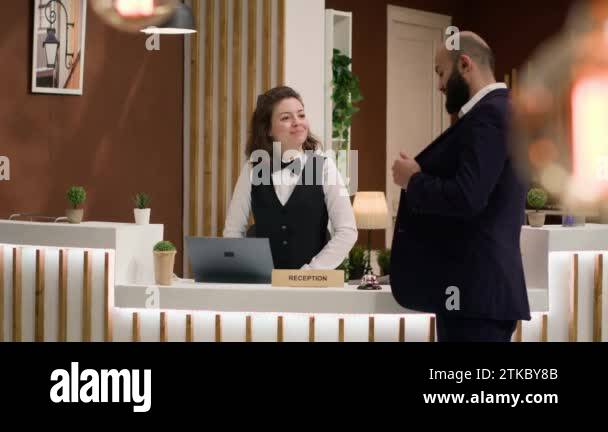 Hotel concierge verifying passport id for guest identification ...