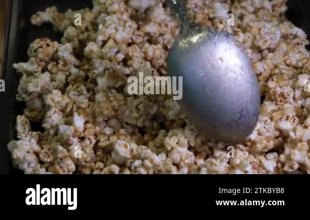 Cooking Popcorn popping on heated fry pan. Slow Motion. Making Popcorn ...