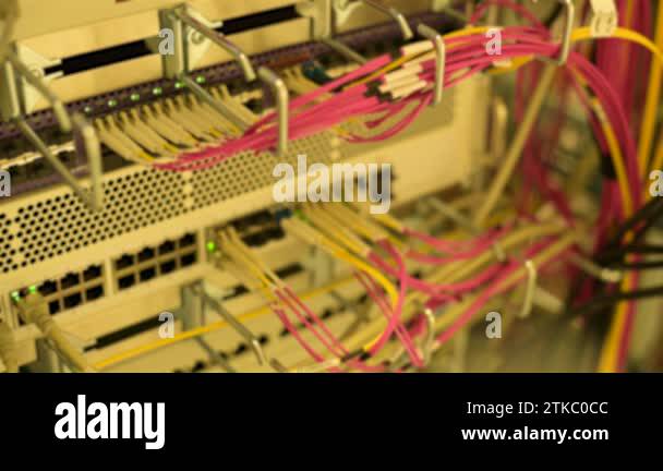 Blurred view of blinking colorful lights or LED lights in a server rack ...