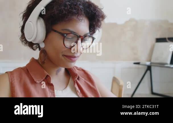 Close-up tilting down shot of face and hands of young African American ...