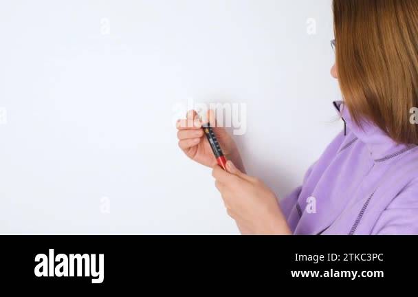 Women or girl thread a disposable needle onto a insulin pen or syringe ...