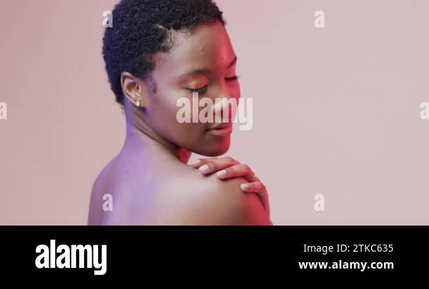 African american woman with short dark hair in blue and pink light with ...