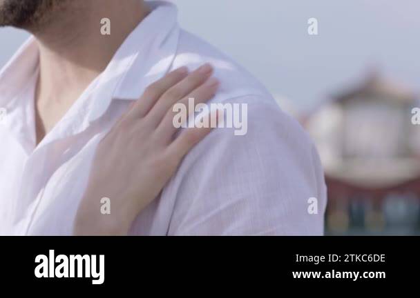 Happy married couple in white clothes hug and touch each other gently ...