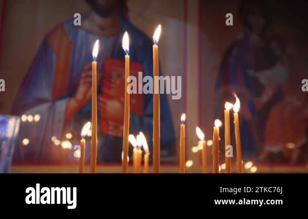 Burning candles in a gilded candlestick in the Orthodox church. The ...