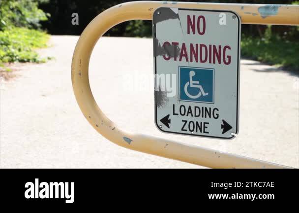 no standing loading zone with handicap symbol and two arrows pointing ...