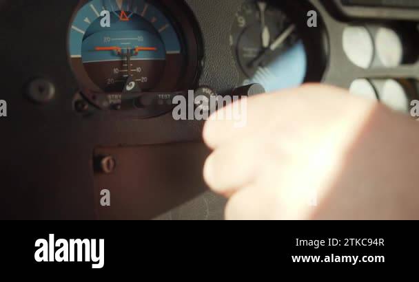 Man adjusting gauges and indicators in helicopter cockpit. Pilot ...