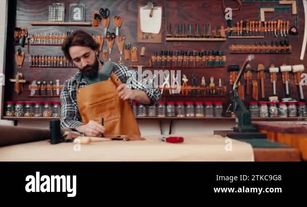 Leather work, man in workshop with tools and craft manufacturing of ...
