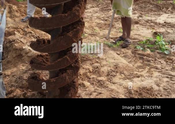 People Operate Hydraulic Post Hole Auger Mounted On Tractor Digging On ...