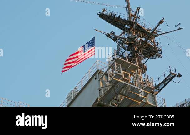 American flag flies on the mast of a warship. View of us flag on navy ...