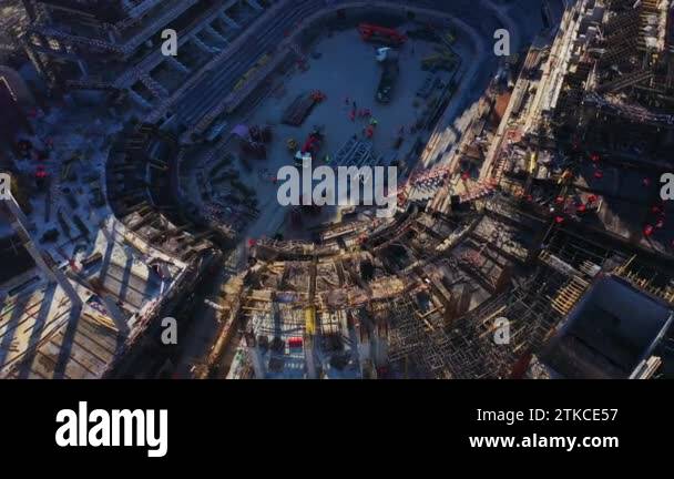 Machinery and cranes operate at construction site of sports arena on ...