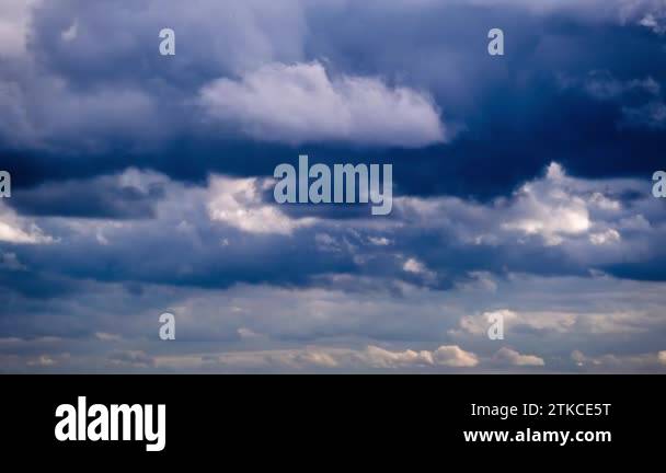 Cumulus clouds move in the sky, timelapse. The background of gray and ...