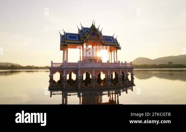 Drone arc shot from left to right of the Khao Tao lake temple up close ...