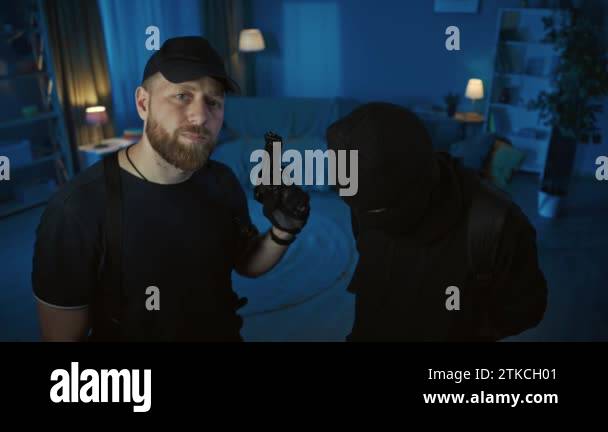 Video of a policeman, cop, looking at the camera, standing next to the ...