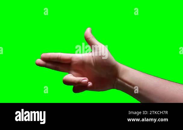 a man's hand forming a gun shoots on a green screen background Stock ...