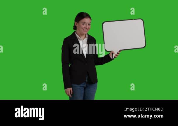 Front view of business manager holding speech bubble on camera, showing isolated cardboard icon ...