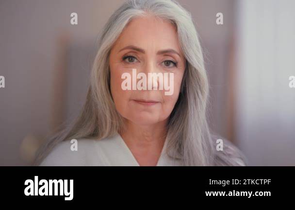 Close up female portrait in bathroom old senior mature 60s lady 50s ...