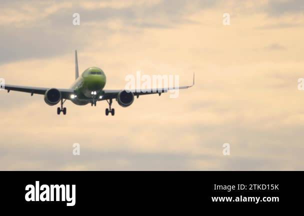 Airplane With Unrecognizable Livery Approaching To Land In A Pink
