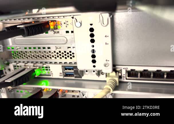 blinking LED lights in a server rack with RJ45 and fiber optic cable ...
