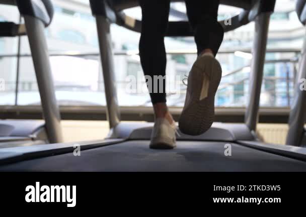 Athlete walking on fitness treadmill in gym. Treadmill workout of ...