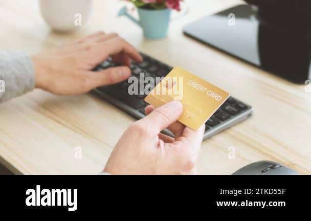 Male hands holding gold credit card making e bank online payment. Man ...