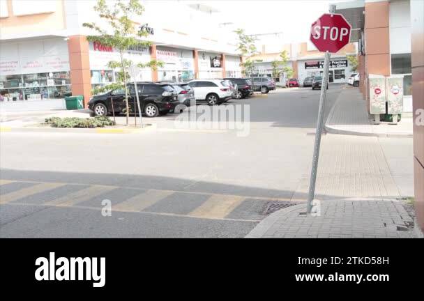 small mini miniature stop sign on metal post outside outdoors in mall ...