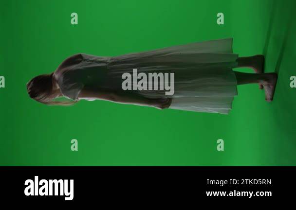 Full-size vertical green screen, chroma key video of a posessed female ...