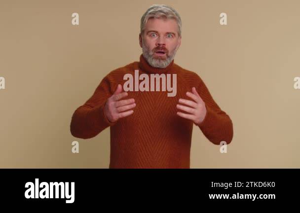 Excited amazed middle-aged man touching head and showing explosion ...