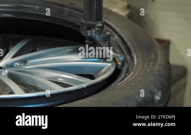 Tyre Fitting. Mechanic using hydraulic or mechanical press to remove ...