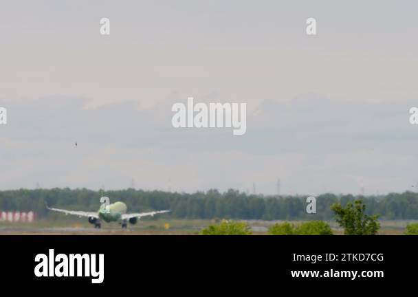 Unrecognizable jet plane departure, climb, rear view. Commercial ...