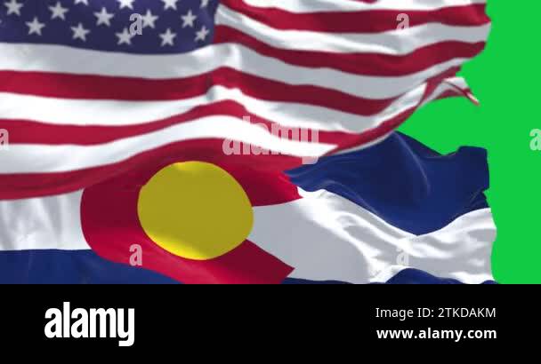 Flags of Colorado and the US waving in the wind isolated on green ...