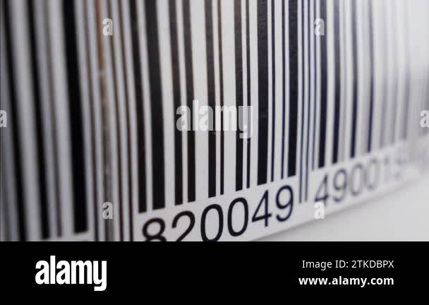 Barcode label scanning with red laser strip. Production line, close up ...