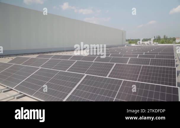 Modern solar energy farm on the warehouse roof. Rows of photovoltaic ...