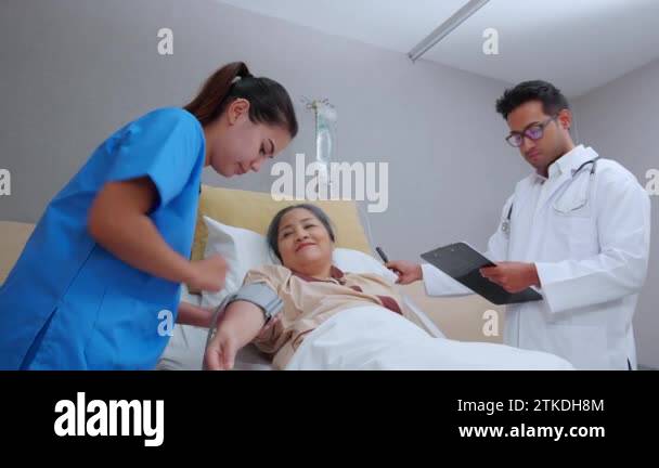 Doctor checkup and diagnostic while nurse measuring blood pressure with ...