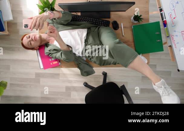 rest at workplace, young woman scrolling mobile phone while having ...