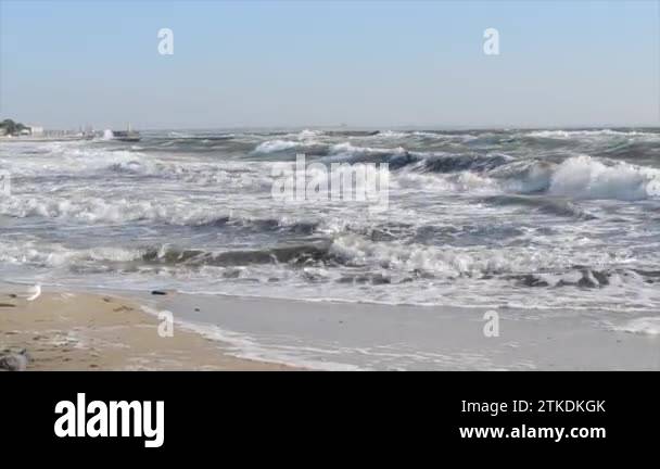 Stormy sea. Sea waves during storm running on sandy beach of sea shore ...