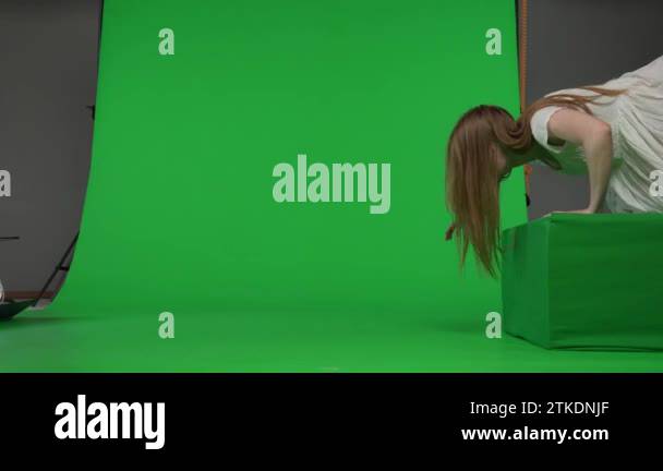 Full-size side view green screen chroma key video of a posessed female ...
