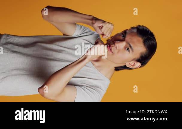 Vertical video: Furious person clenching fists and acting angry ...