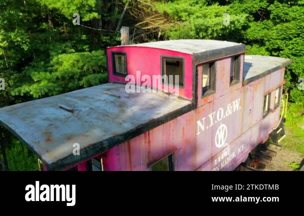 This video shows a view of a red caboose. A caboose is a railroad car ...