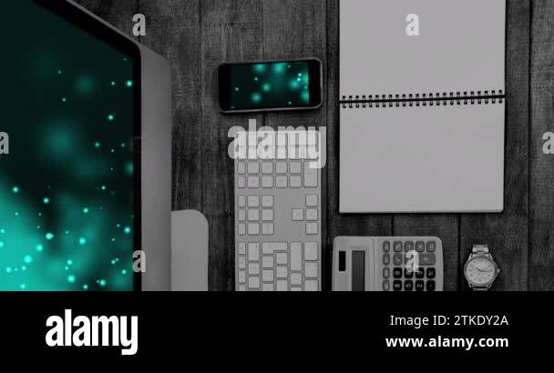 Animation of technological devices with light spots on screen on desk ...