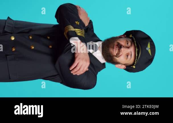 Vertical video: Portrait of smiling aircrew captain posing on camera ...